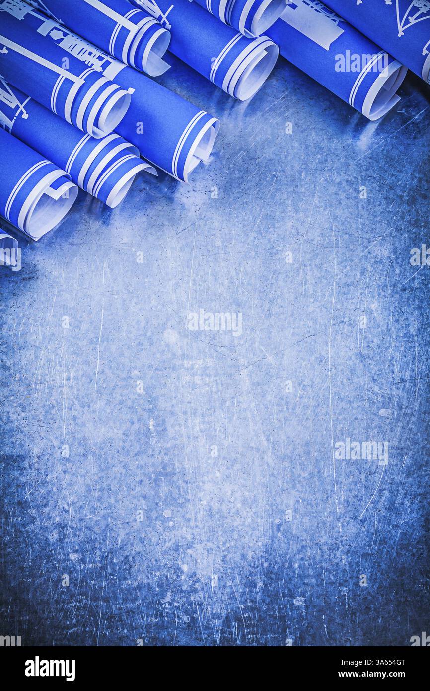 Pile of blue engineering drawings on metallic background construction ...