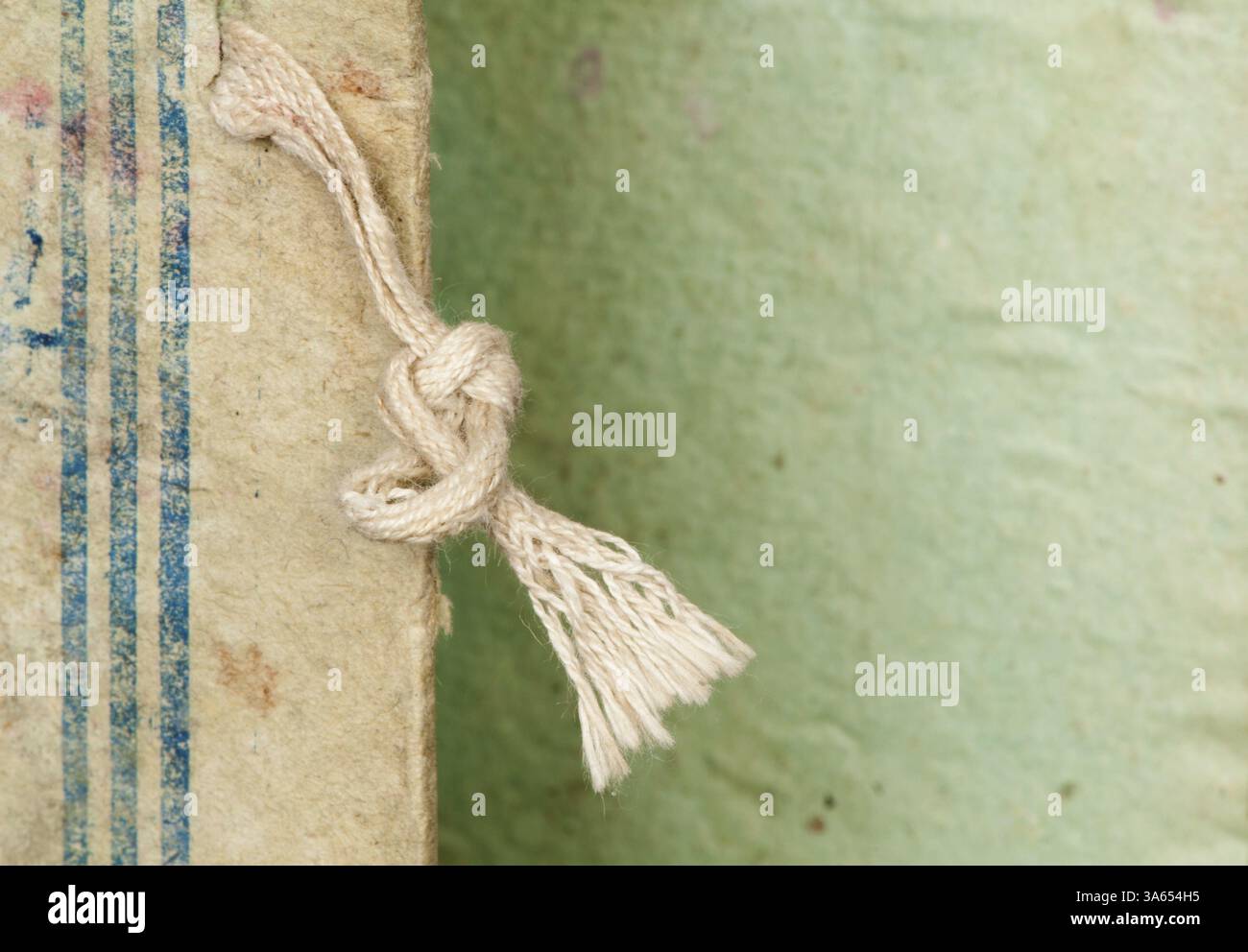 Old tattered folder tied with rope Stock Photo - Alamy