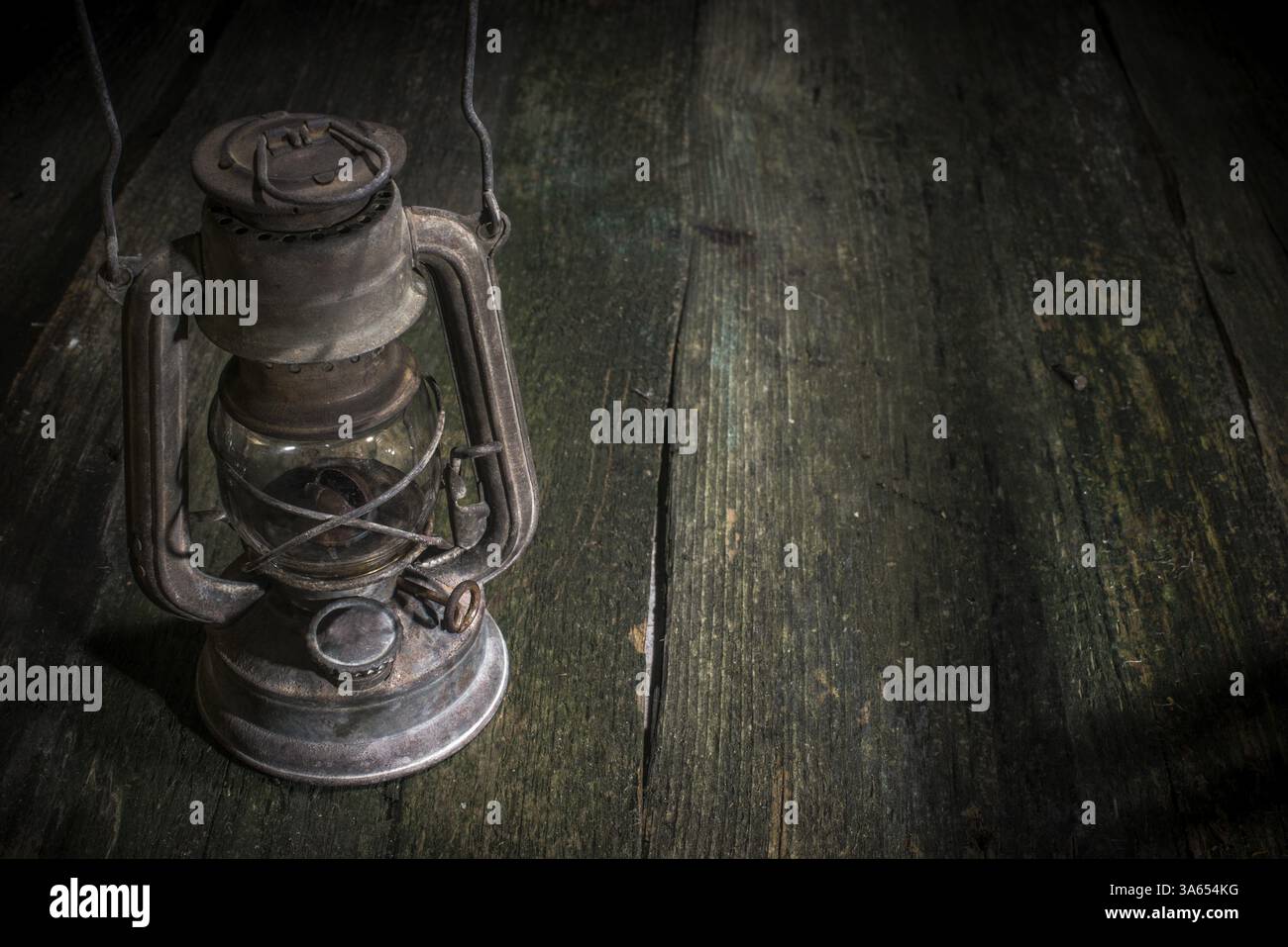 Old gas lantern on wood at darkness Stock Photo - Alamy