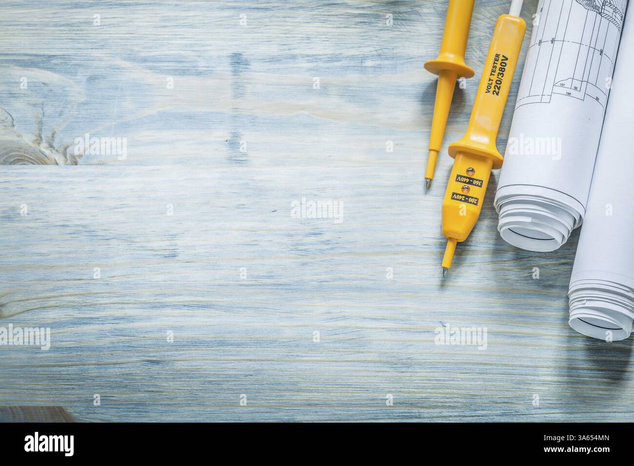 Set of electric tester engineering drawings on wooden board electricity ...