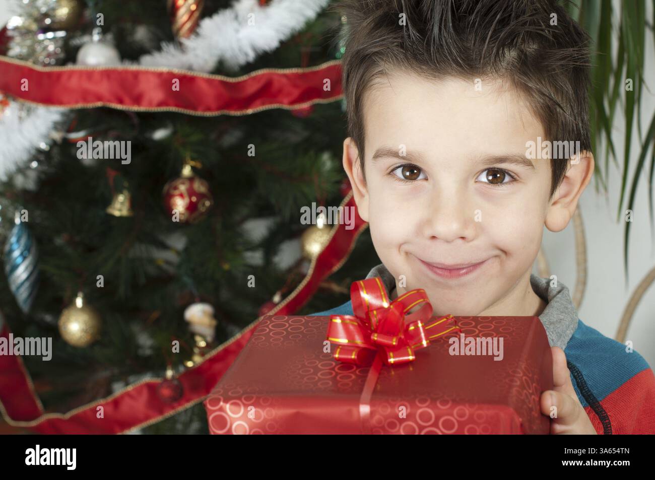 Happy child receive the gift of Christmas in front of the Christmas ...