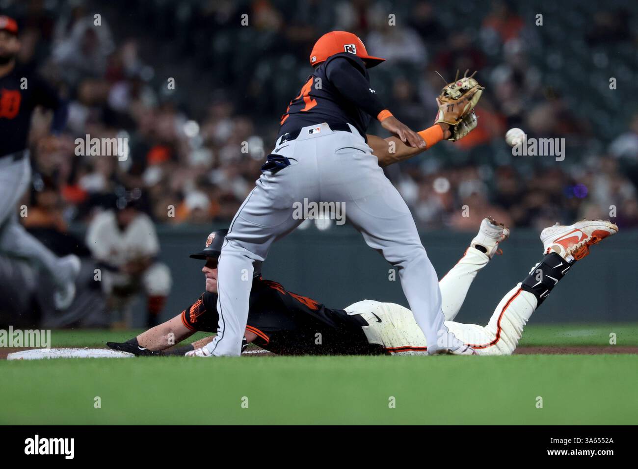 San Francisco Giants' Tyler Fitzgerald, bottom, slides into third base ...