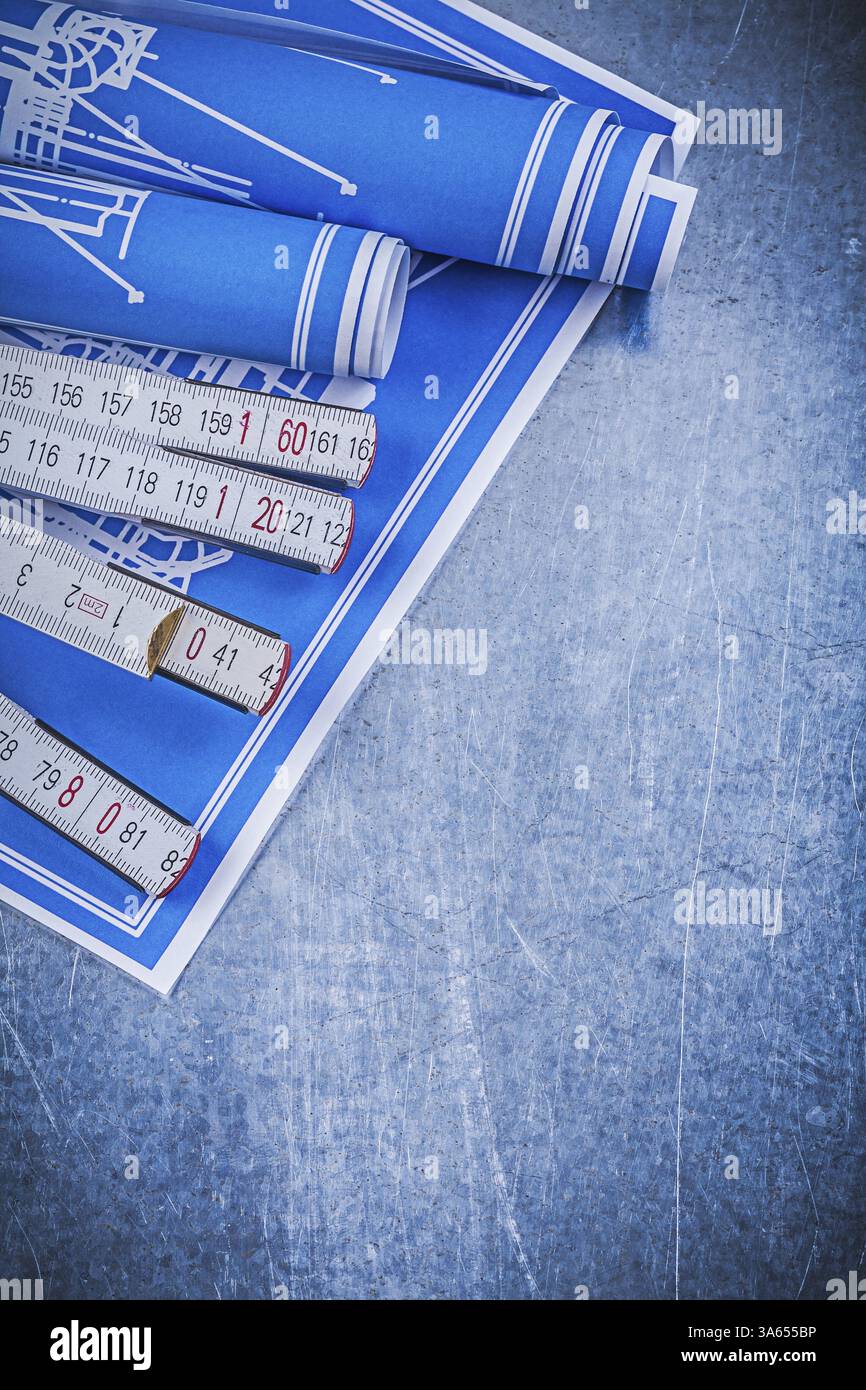 Blue construction drawings wooden meter on metallic background ...