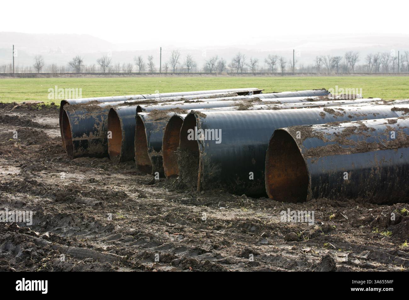 Old metal pipes dismantled for scrap placed on land Stock Photo - Alamy