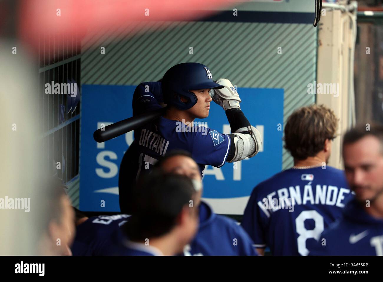 Los Angeles Dodgers' Shohei Ohtani warms up in the dugout during the ...