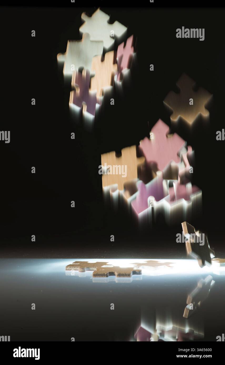 Falling puzzle pieces.Backlight background Stock Photo - Alamy
