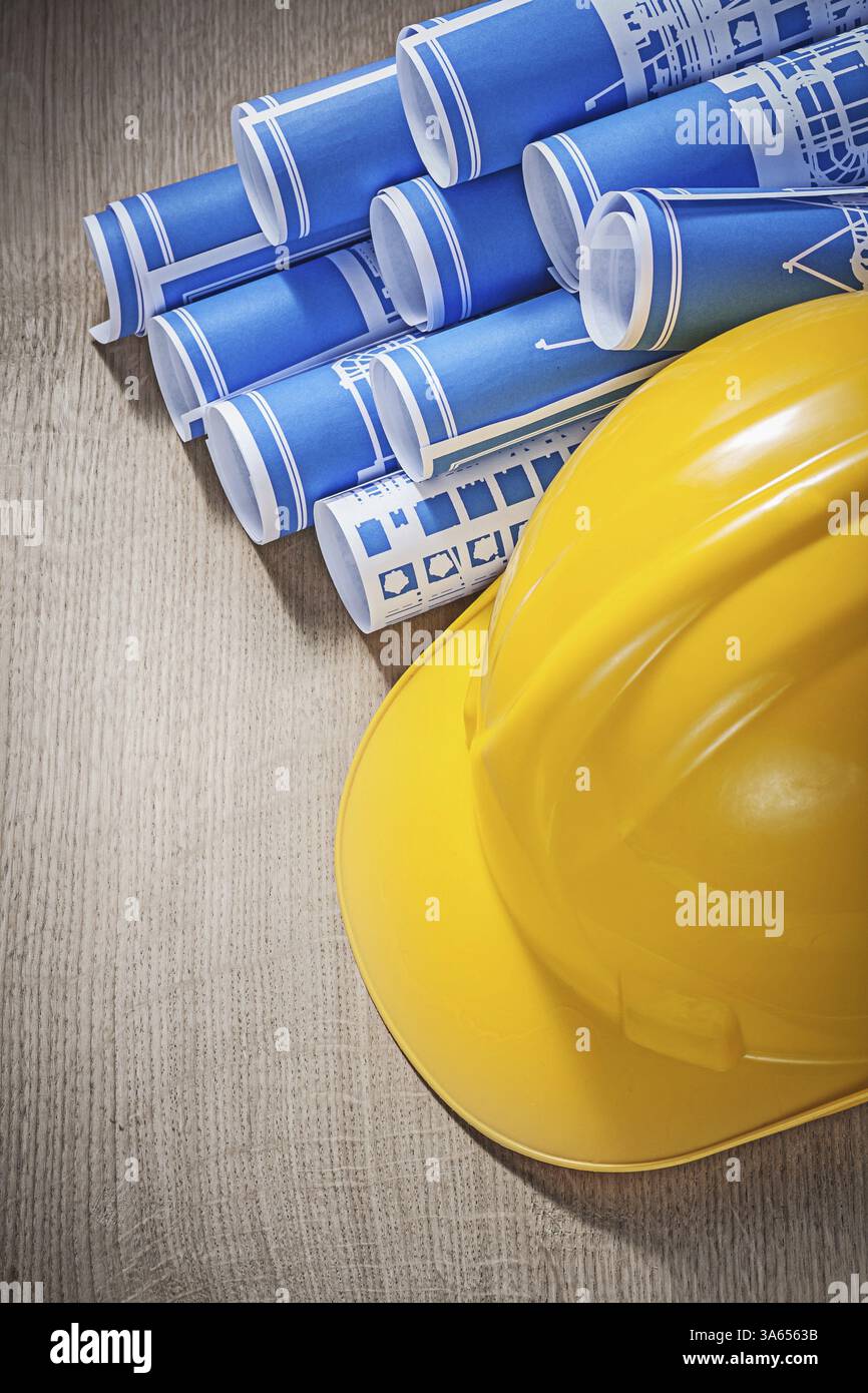 Blue engineering drawings hard hat on wooden board construction concept Stock Photo - Alamy