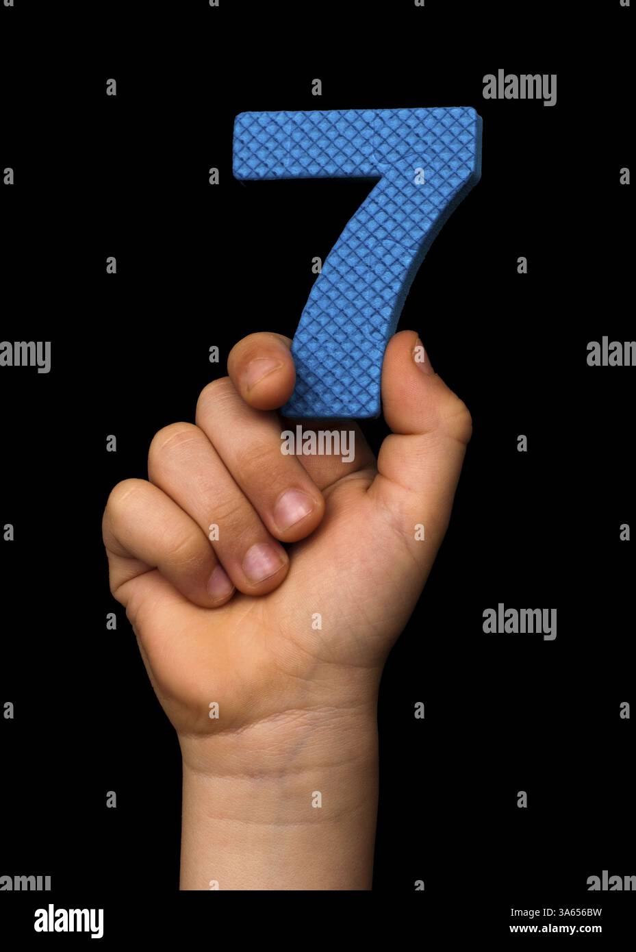 Children hand holding the number Seven. Black isolated blue color ...