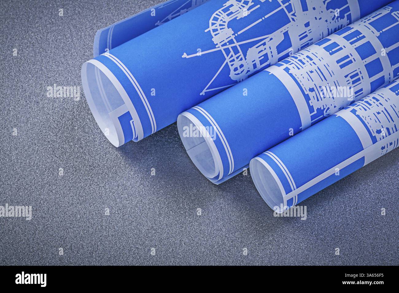 Blue rolled up blueprints on grey surface construction concept Stock ...