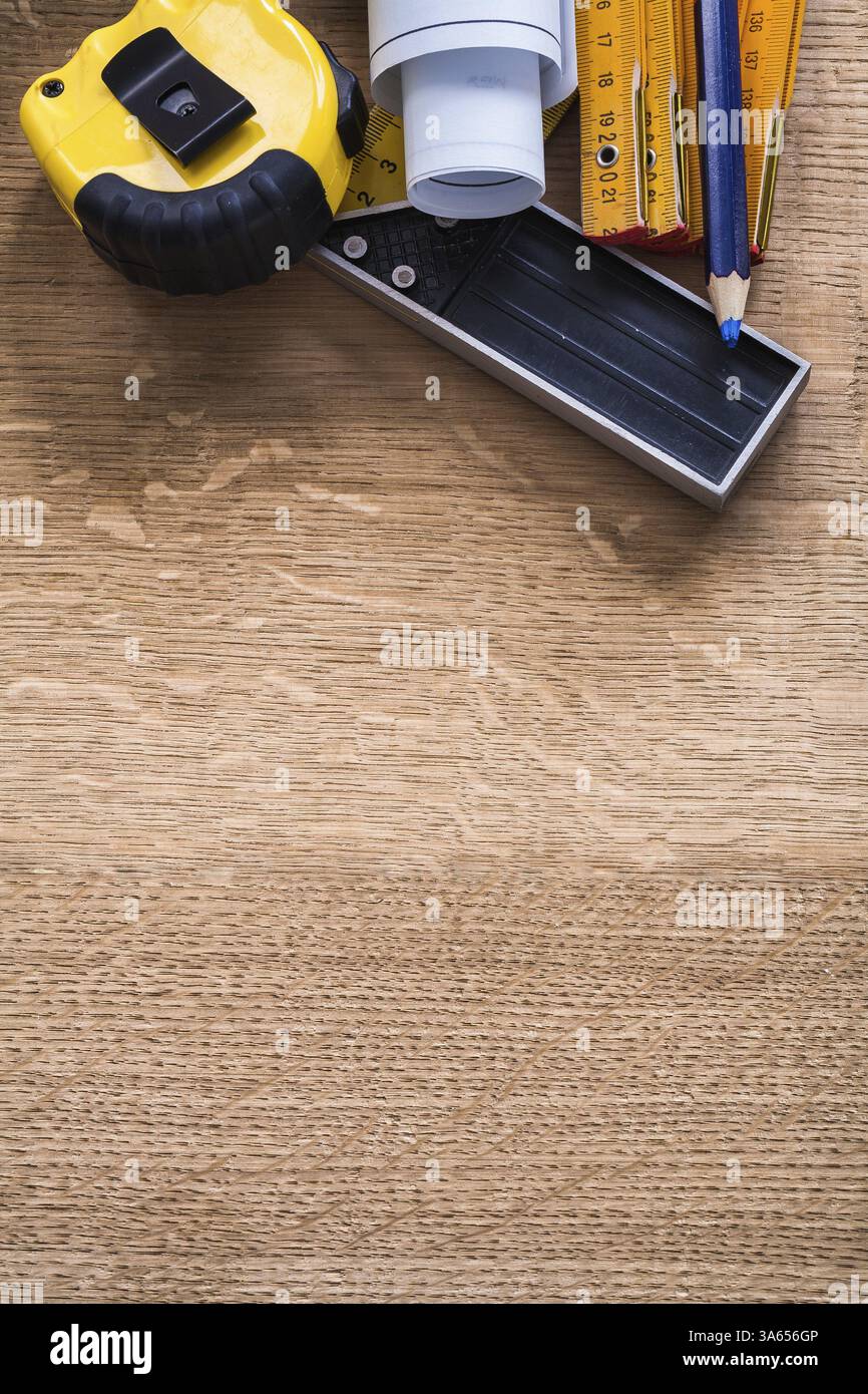 Blueprints square ruler tape measure pencil and wooden meter on oak ...