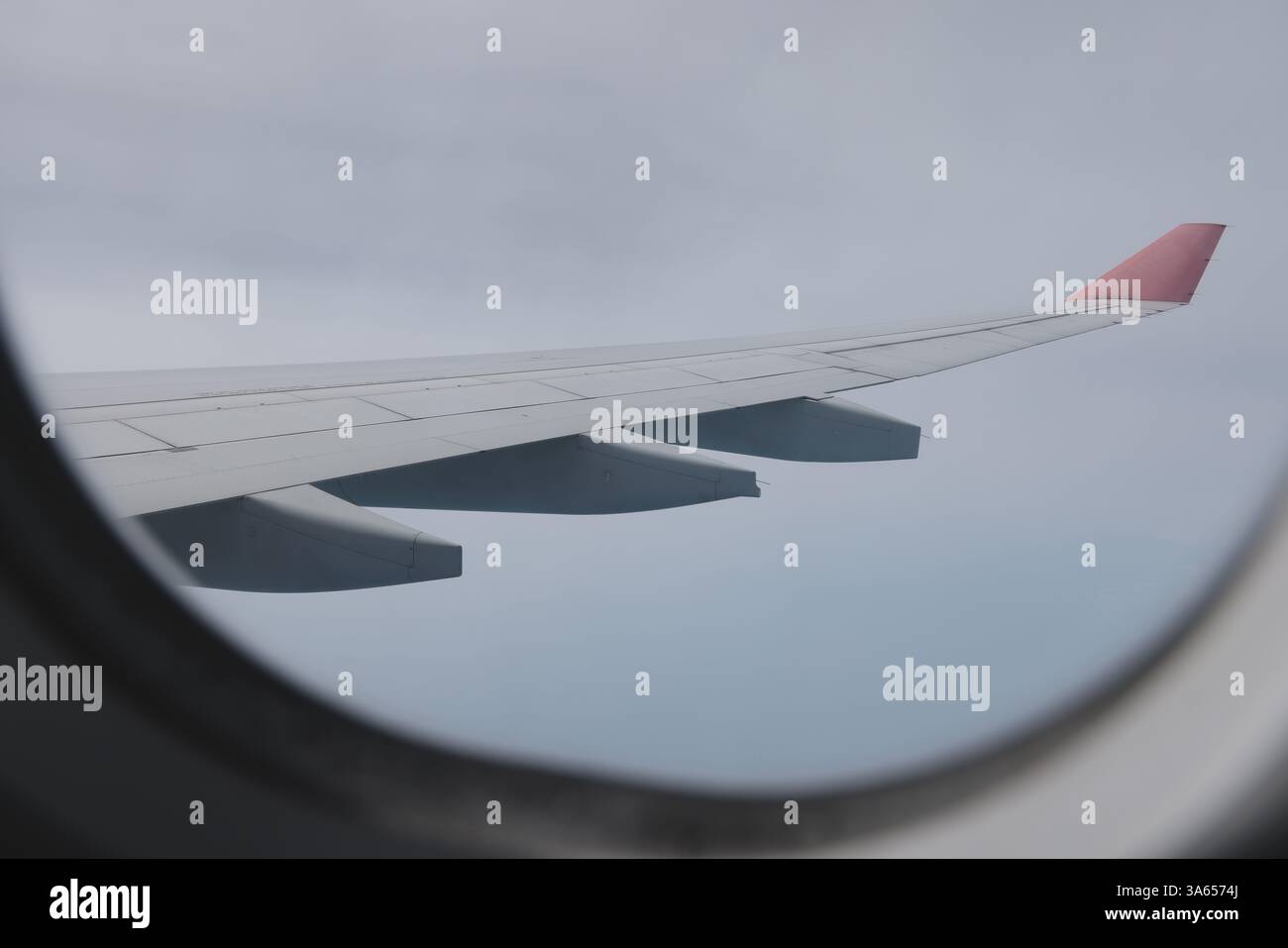 A breathtaking aircraft wing view high above the clouds during a ...