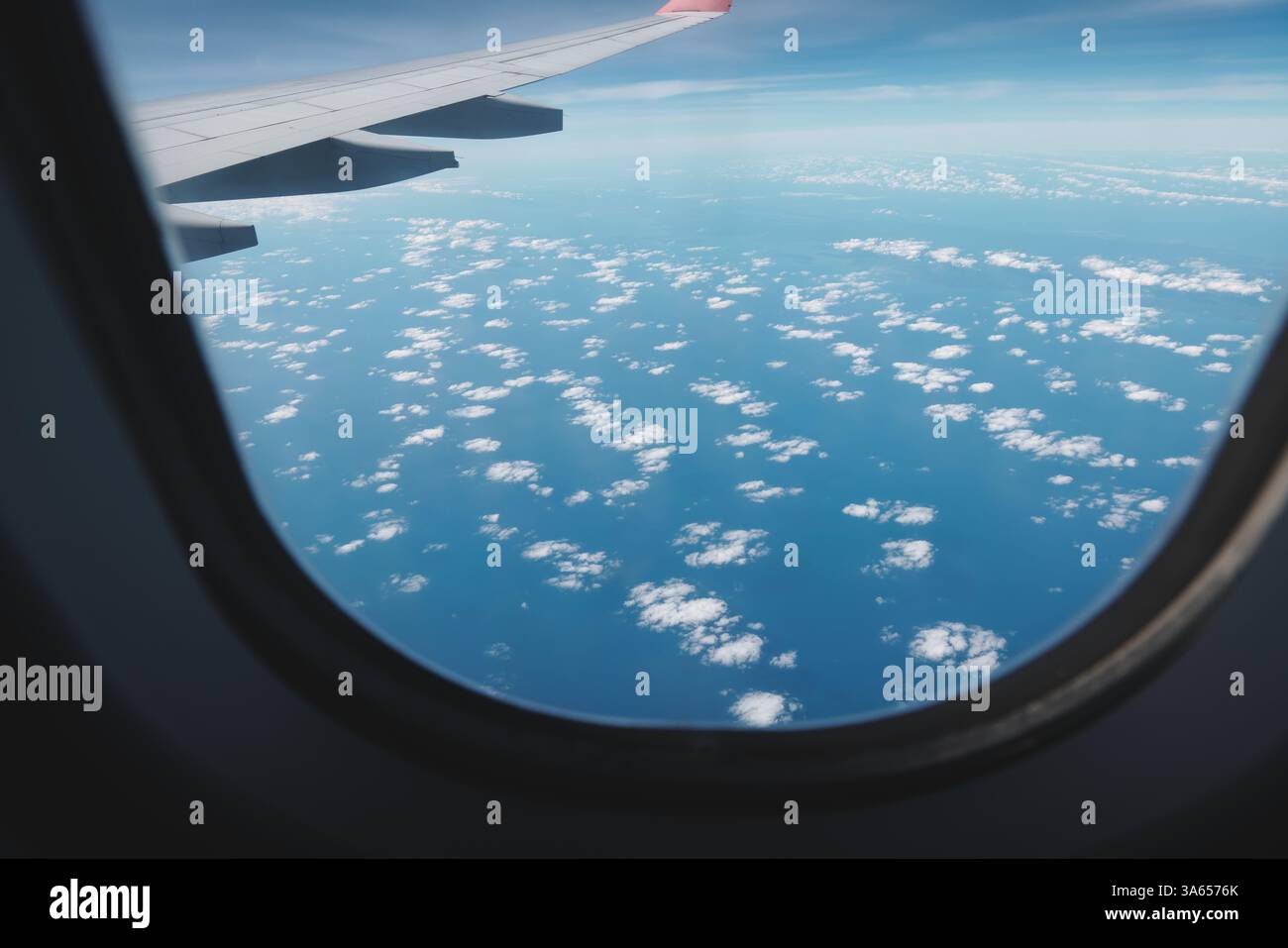 An aerial view of beautiful clouds above the vast blue ocean from an ...