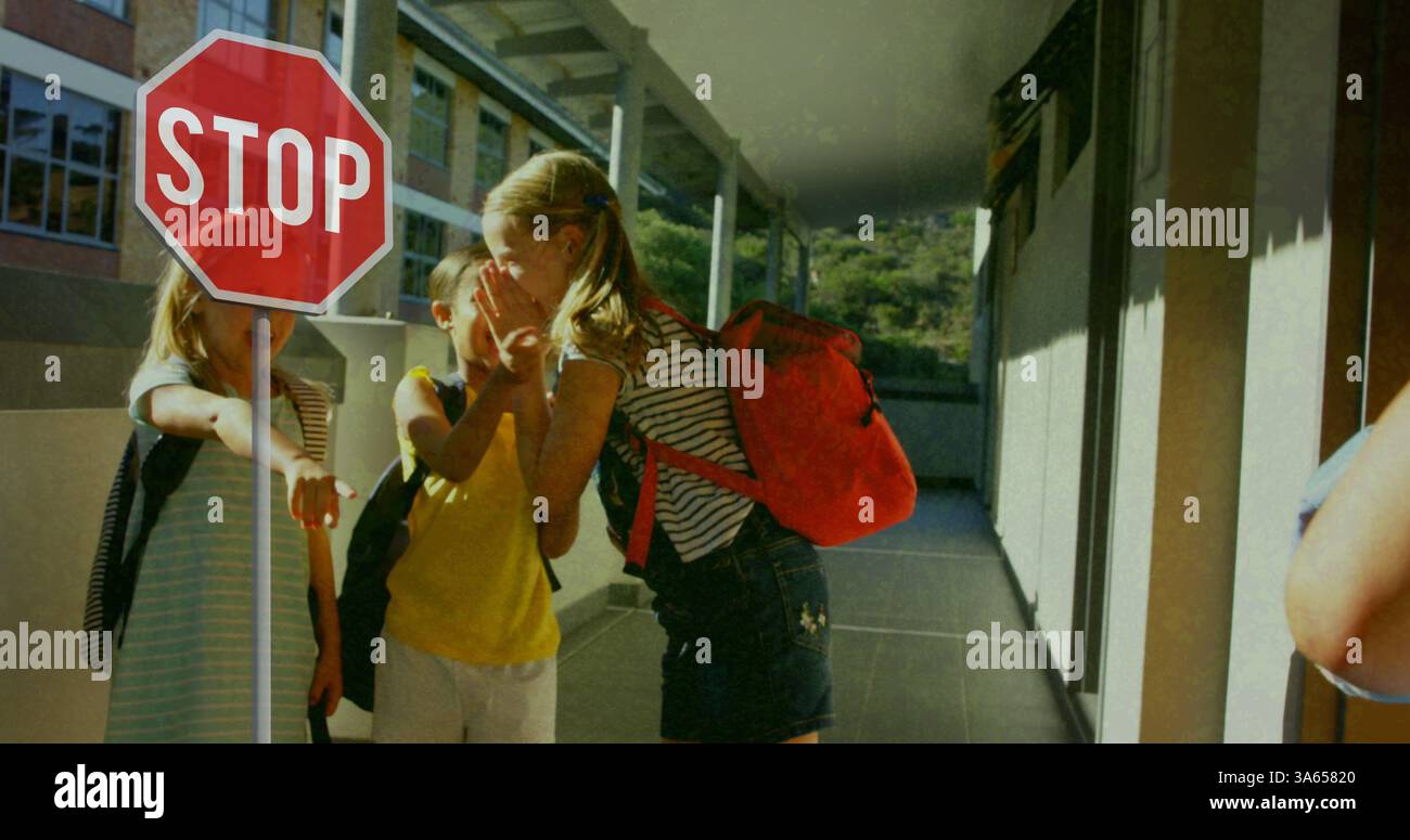 School children with backpacks laughing and playing near stop sign ...