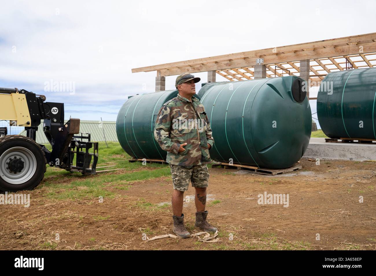 Warren Aganos poses for a portrait in front of the water tanks at ...