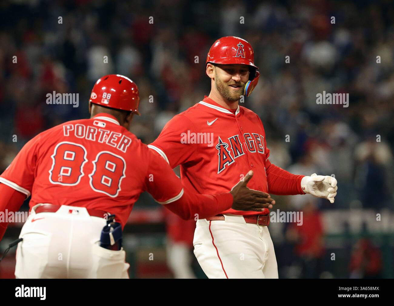 Los Angeles Angels' Taylor Ward is congratulated by first base coach Bo ...