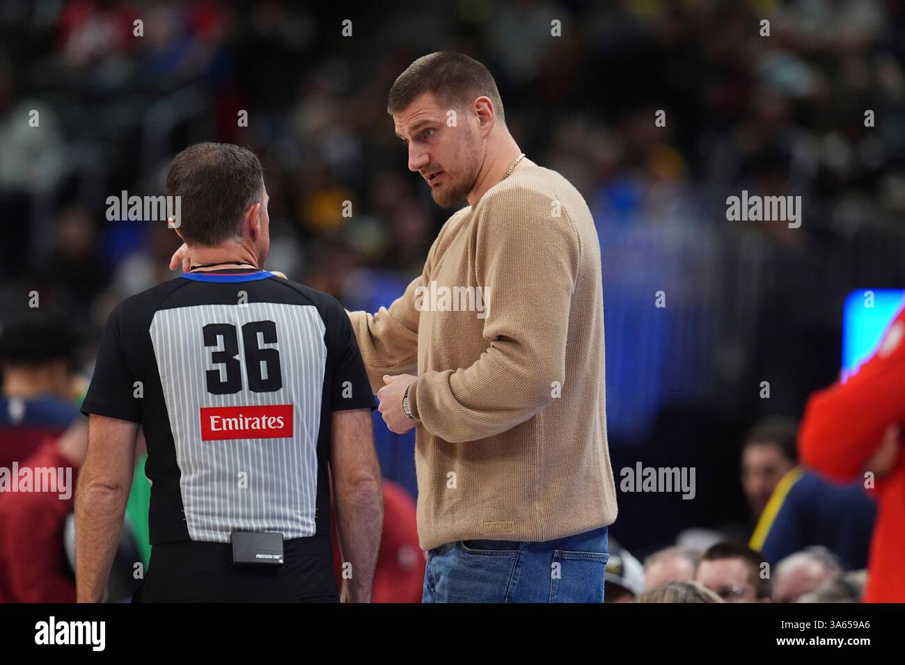 Injured Denver Nuggets center Nikola Jokic, center, confers with ...