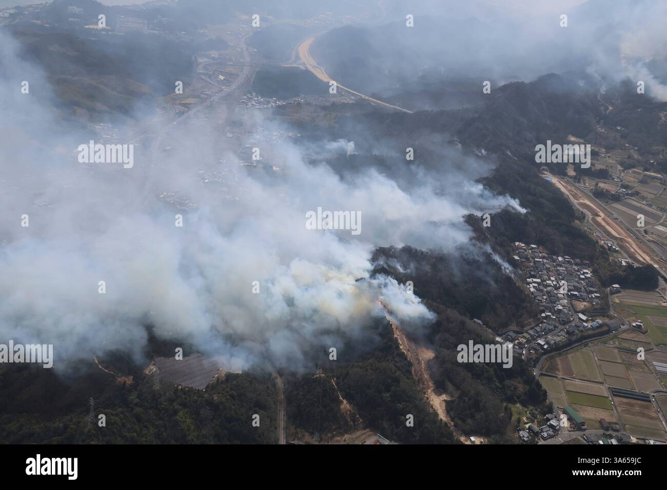 An aerial photo shows a spreading forest fire in Imabari, Ehime ...