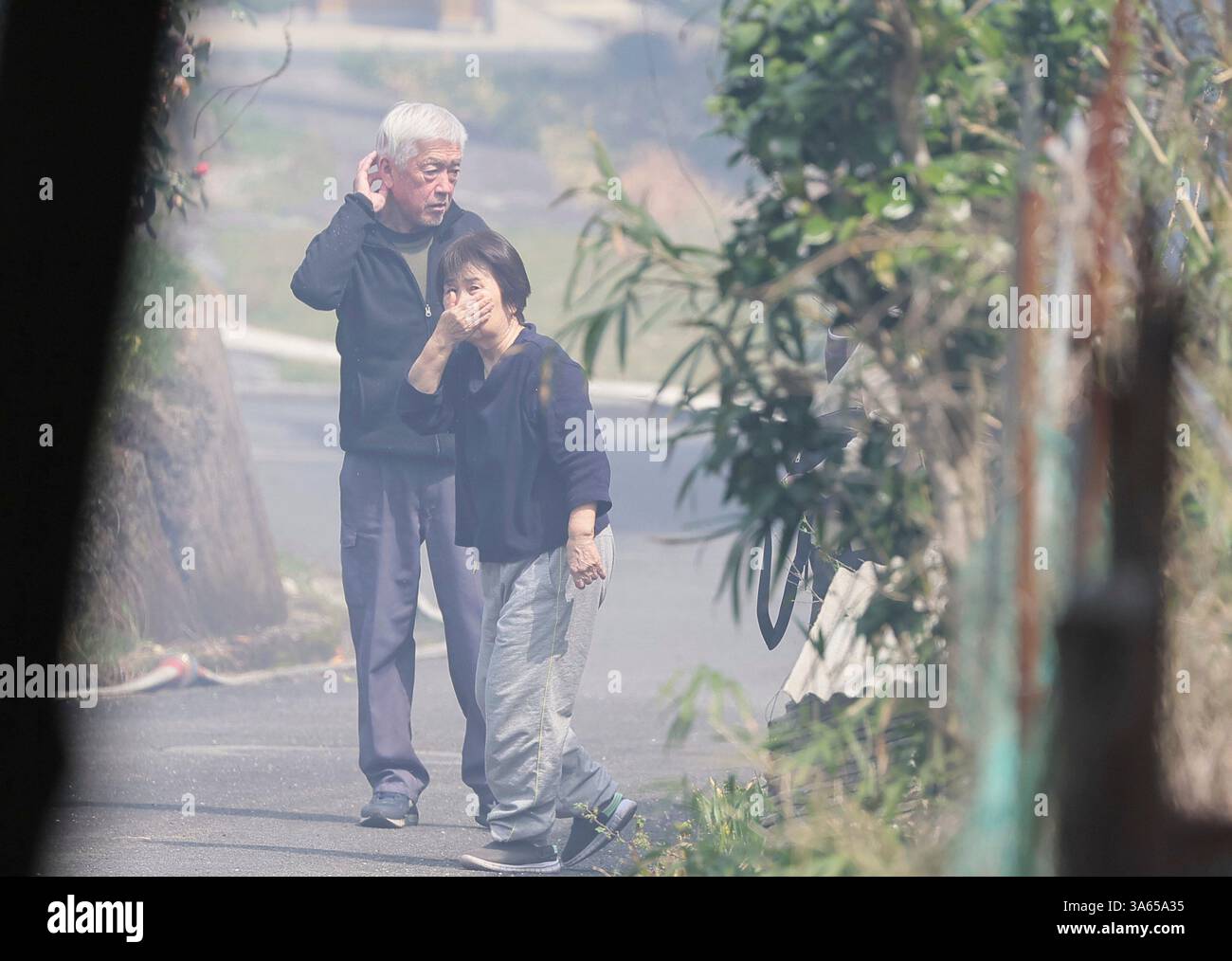 The photo shows a village engulfed in smoke from a spreading forest ...