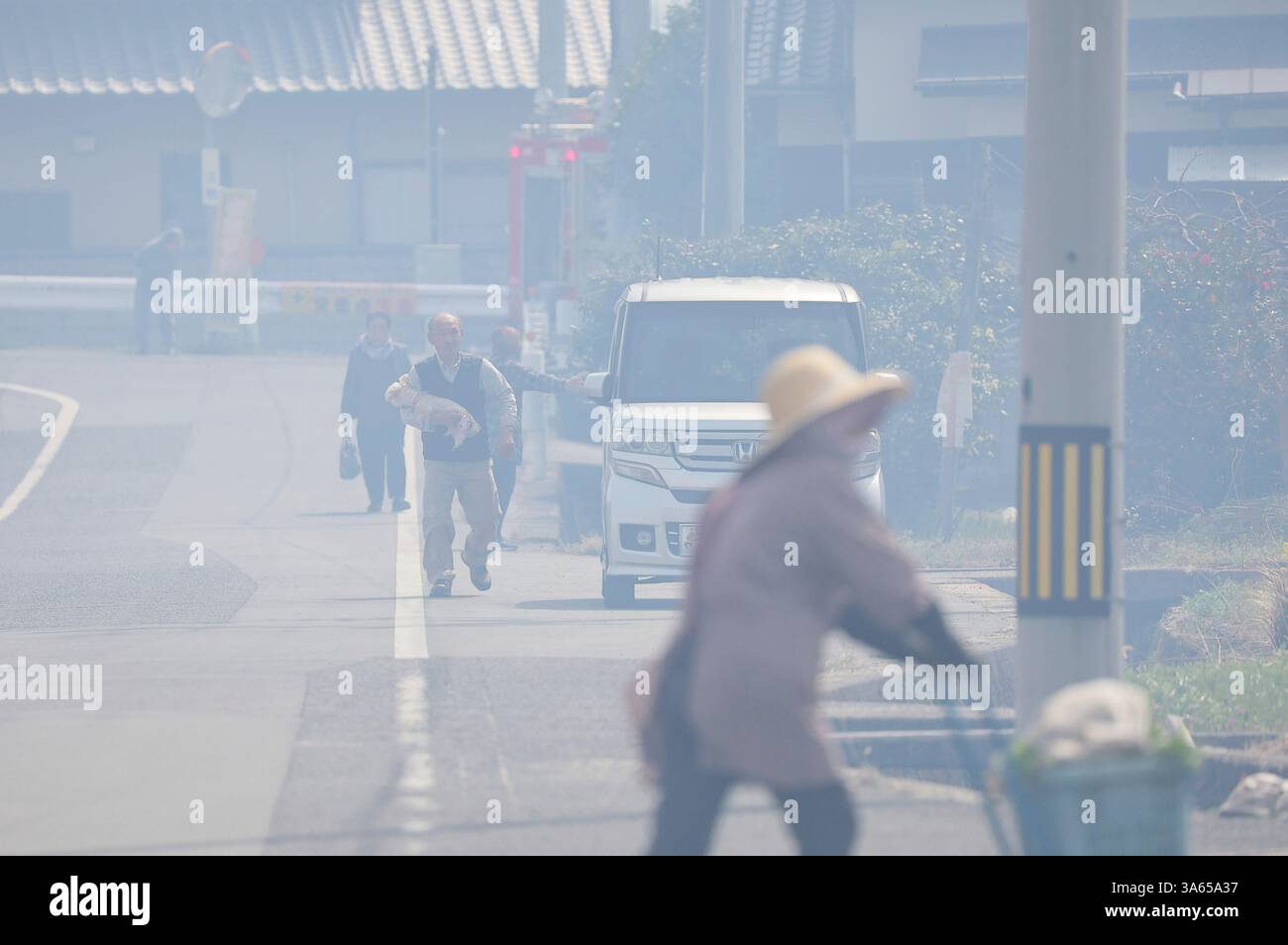 The photo shows a village engulfed in smoke from a spreading forest ...