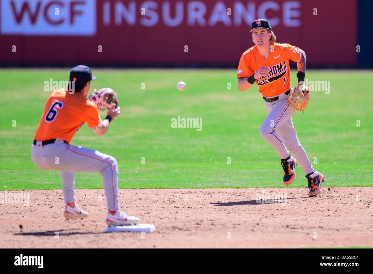 Oklahoma State infielder Brock Thompson (1) tosses the ball to ...