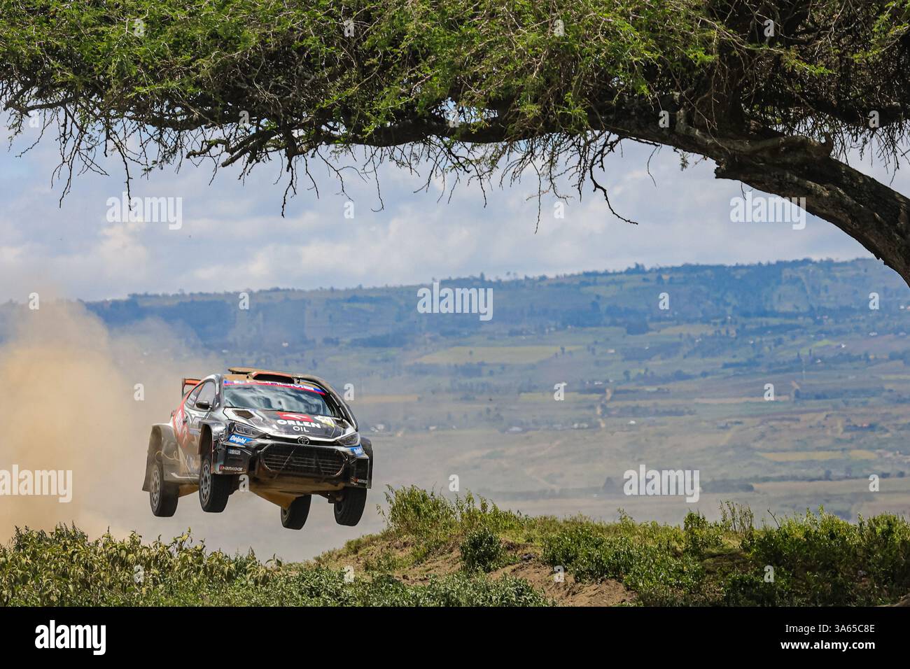 A photo of a rally over a jump at Miti-Mbili Kedong 1. Safari Rally ...