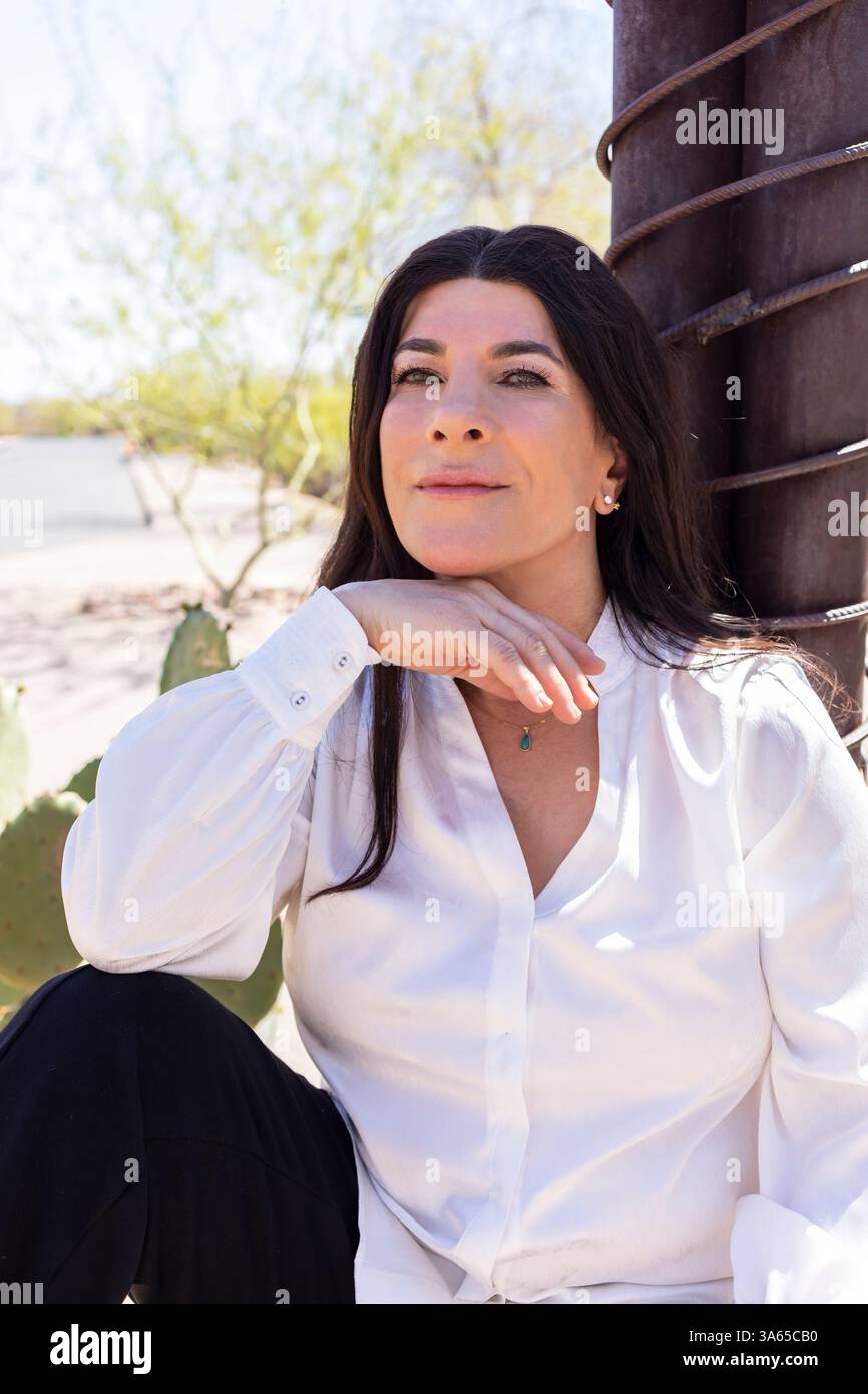 Portrait Of Chilling Lebanese Woman In Her 50s in White Shirt Outside ...