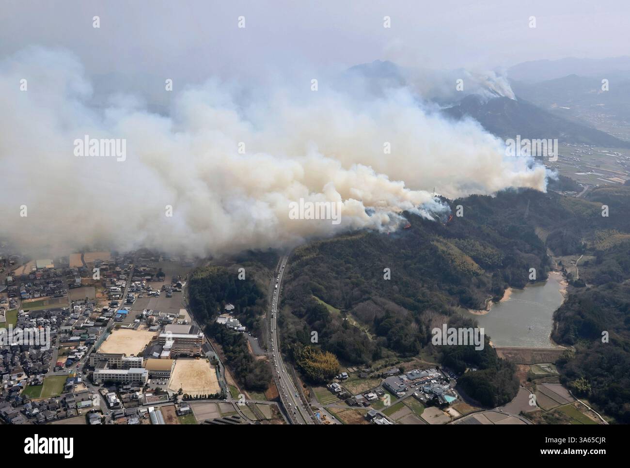 An aerial photo shows a spreading forest fire in Imabari, Ehime ...
