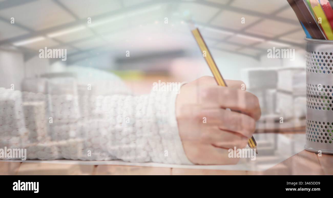Image of woman using computer keyboard and writing with stacks of boxes ...