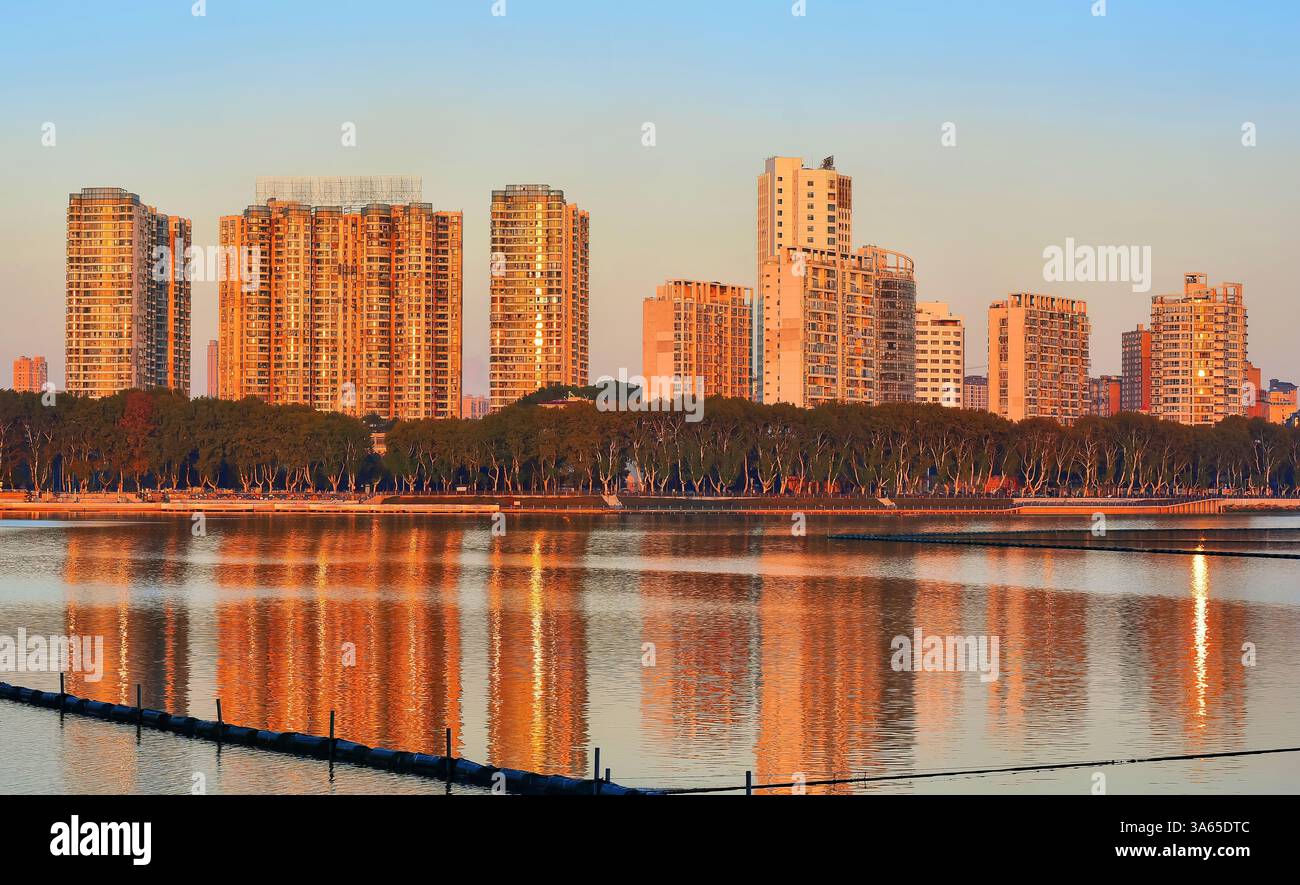 Cityscape of Jiujiang City at sunset over the Sai Lake, Jiangxi ...