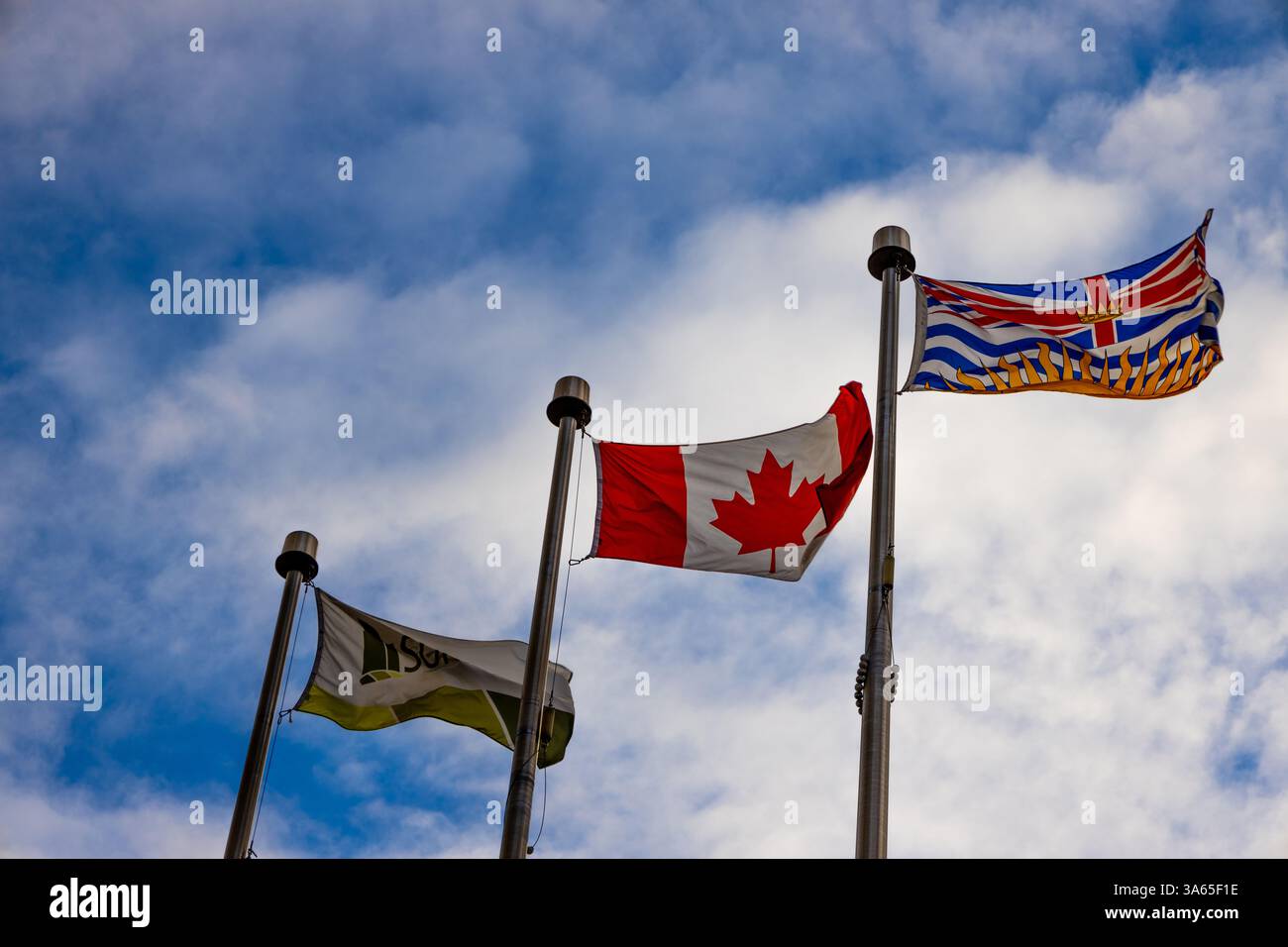 Canada, British Columbia, and Surrey flags with blue sky, March 2025 ...