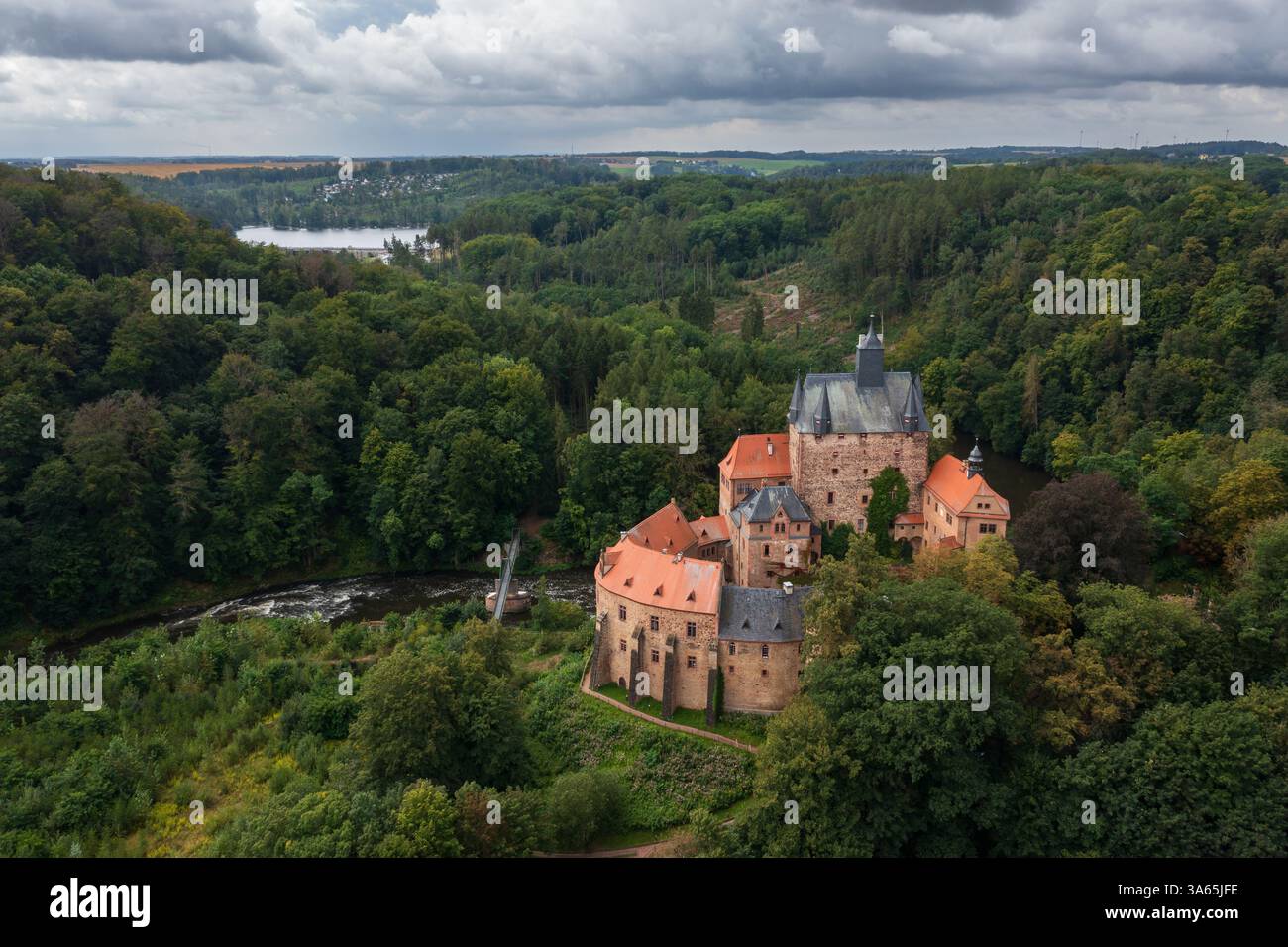 Aerial view of medieval Kriebstein Castle, perched on rocky cliff on ...