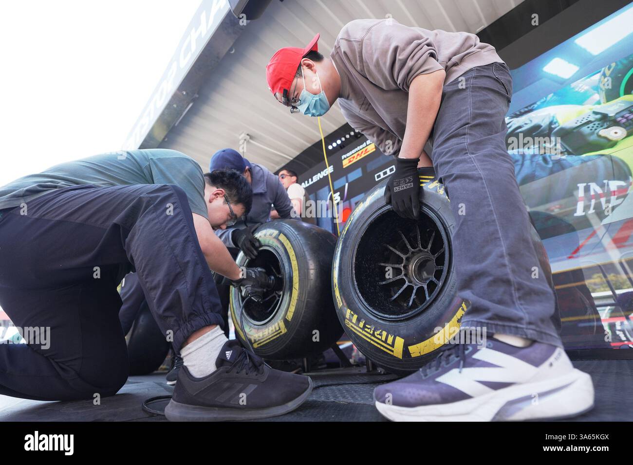 F1 fans learn changing tires for a racing car, March 21, 2025. Shanghai ...