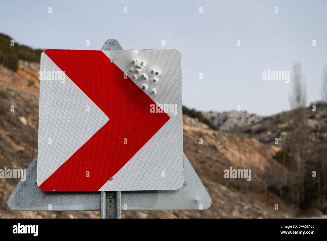 Traffic sign with bullet holes in it Stock Photo - Alamy