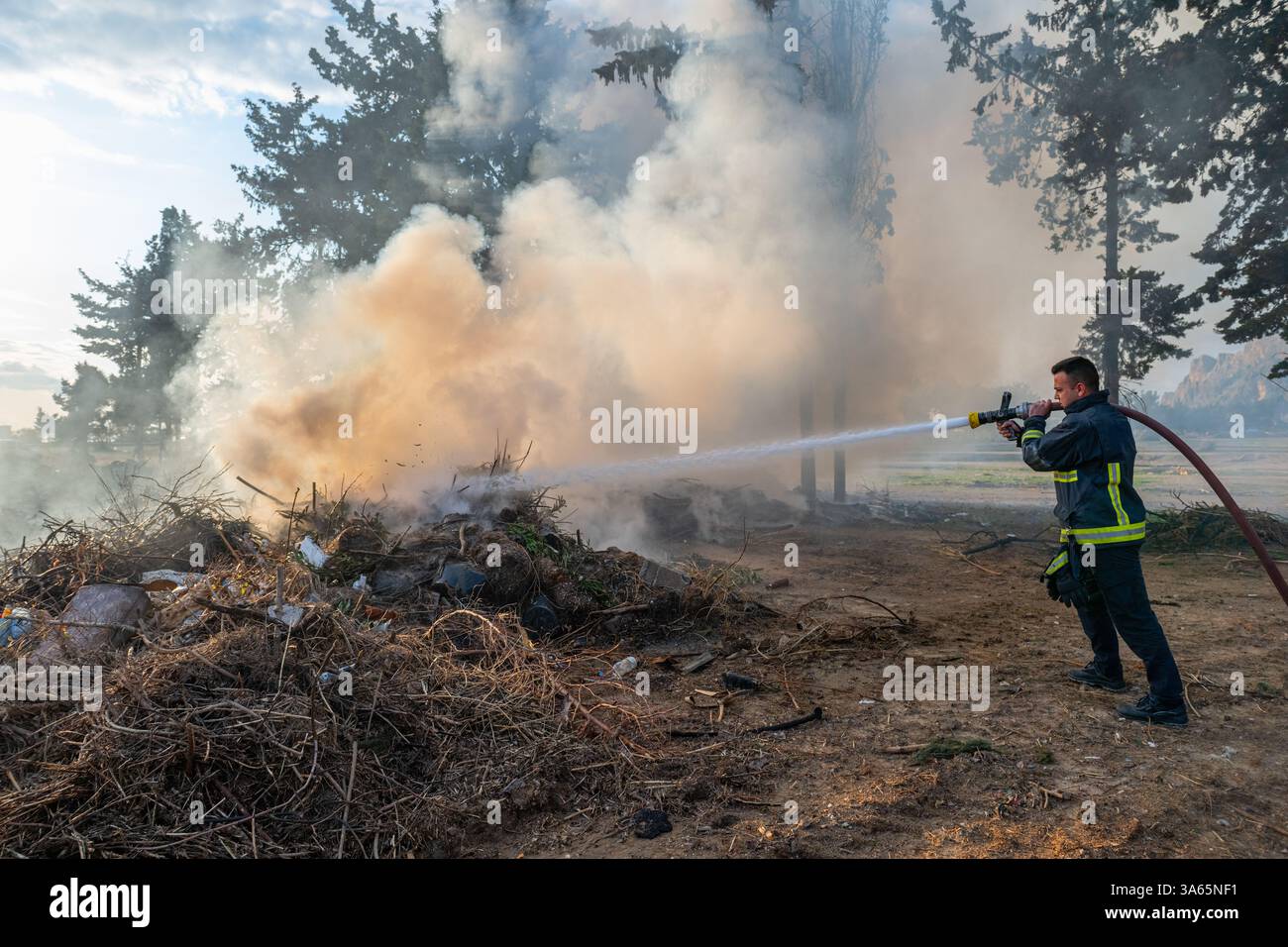 The firefighter is fighting the fire Stock Photo - Alamy