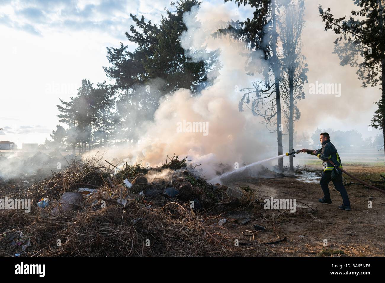 The firefighter is fighting the fire Stock Photo - Alamy