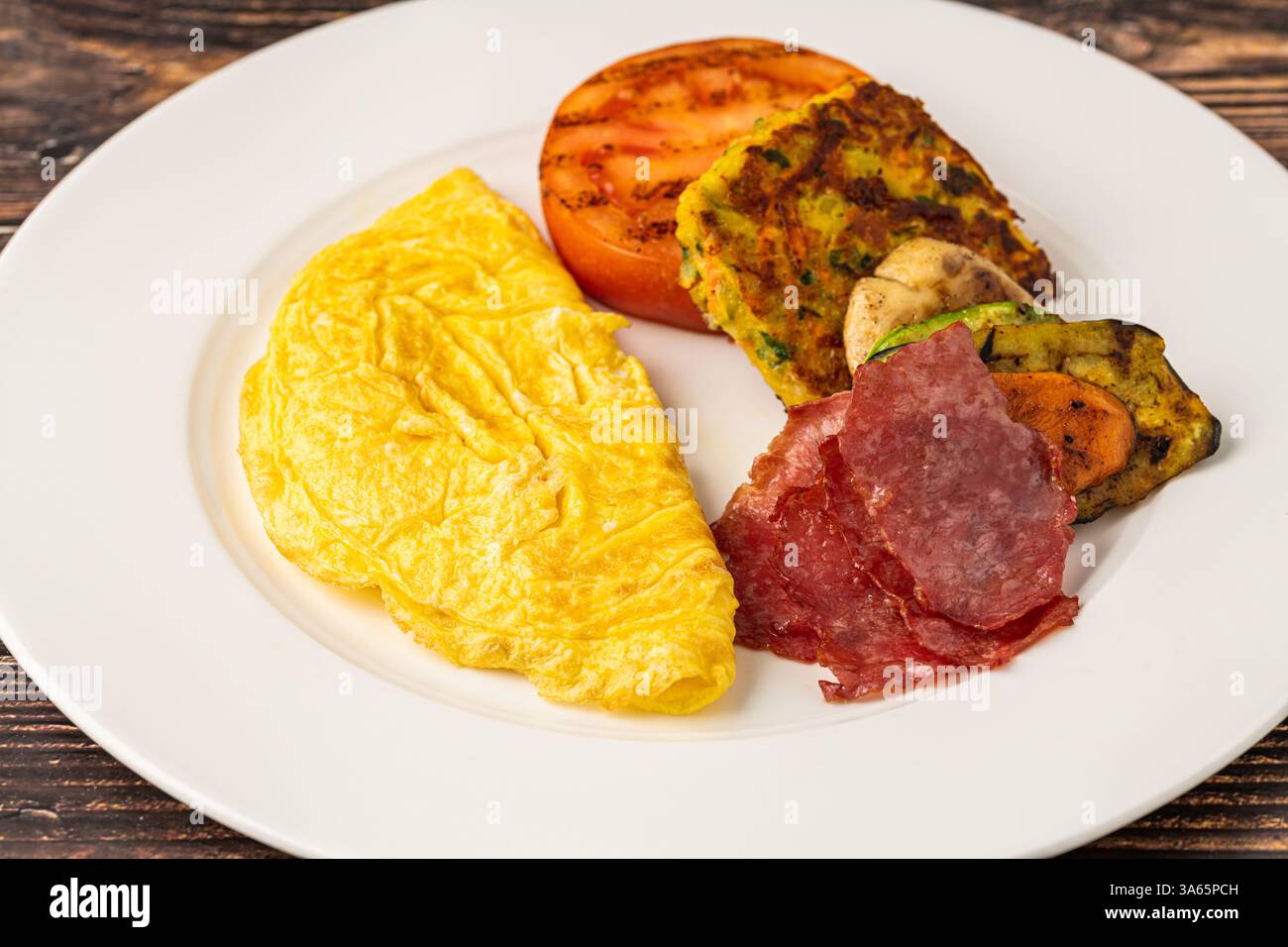 Rustic breakfast plate with fried eggs, grilled vegetables, and turkey ...