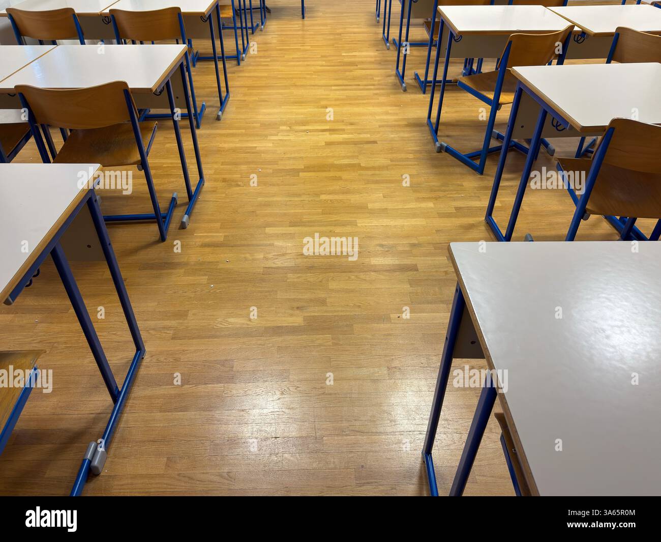 Empty Classroom with Wooden Floor and Student Desks Stock Photo - Alamy