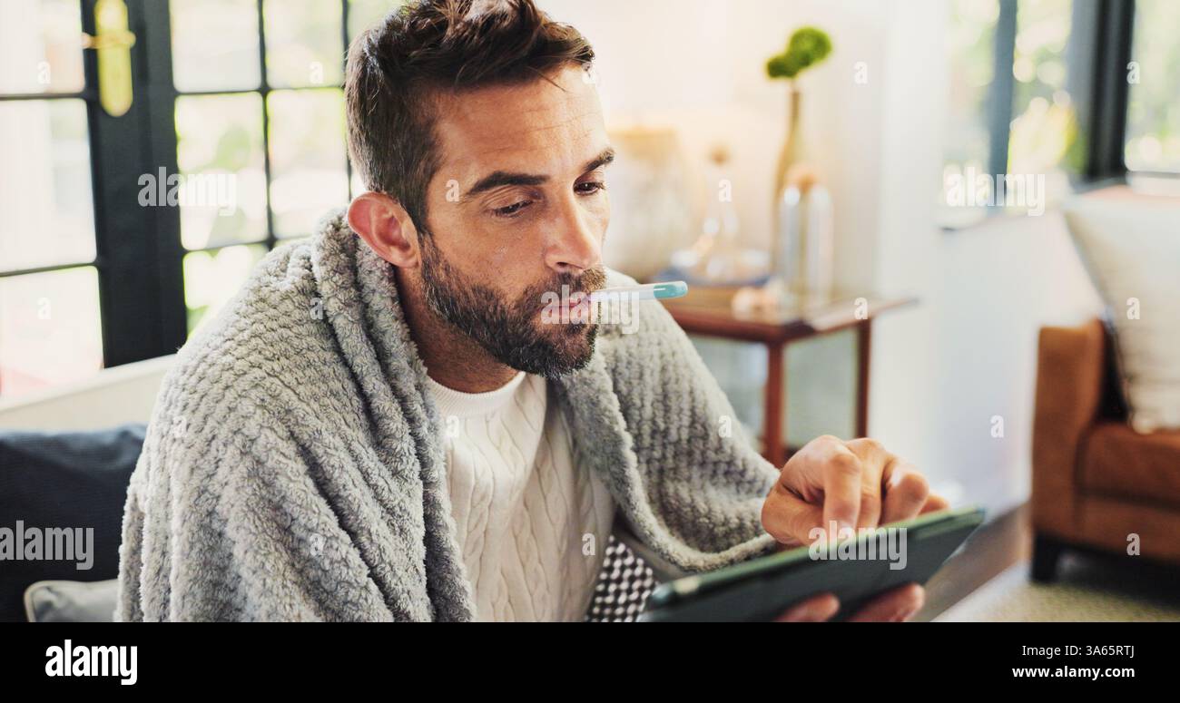 Home, man and sick with tablet for thermometer, check fever and ...