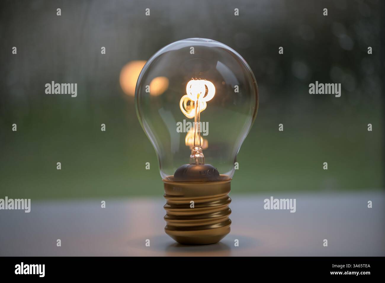 A glowing light bulb representing creativity, innovation, and ideas, placed on a neutral ...