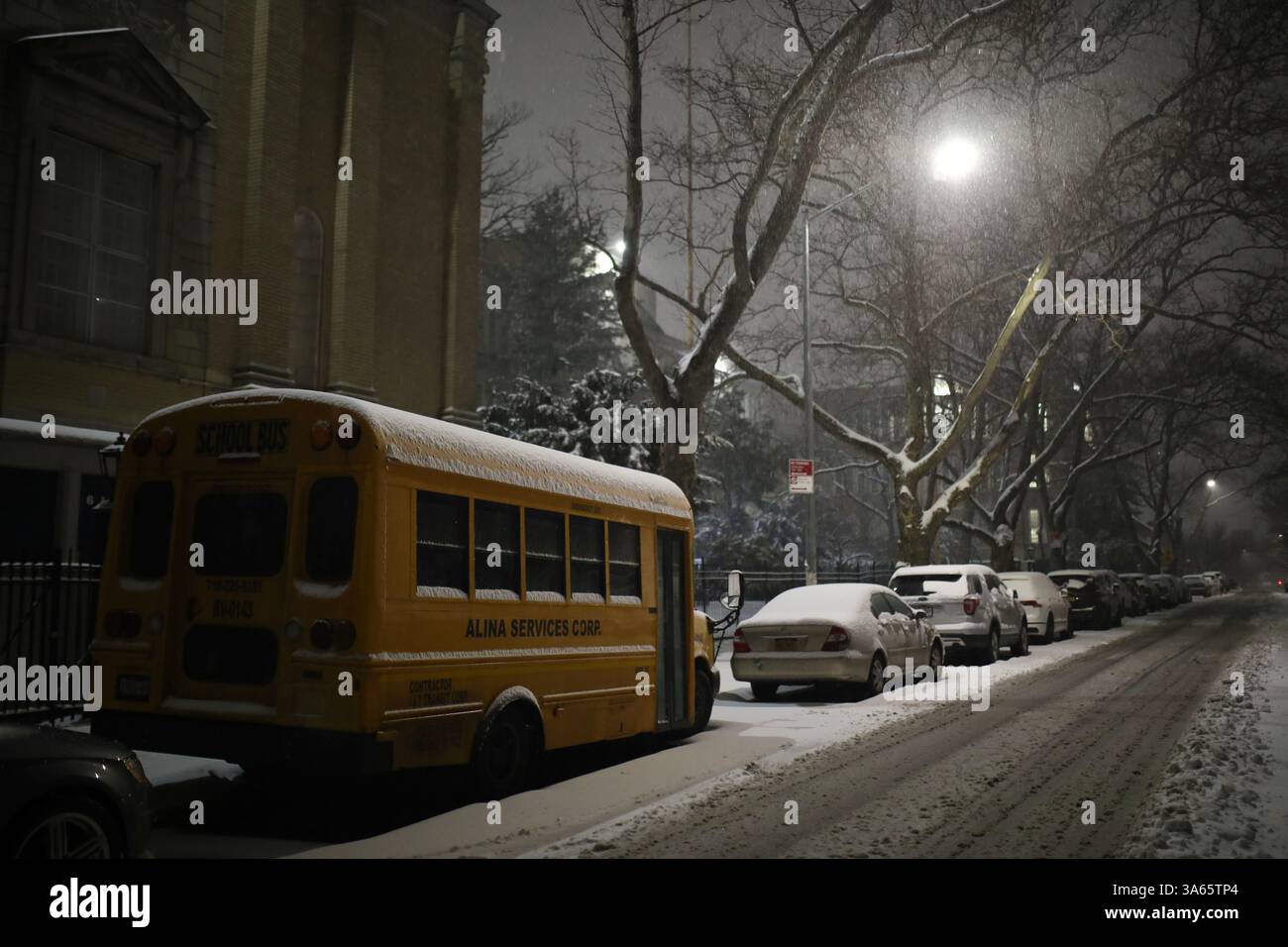A parked school bus seen on a snow-covered street in the Ridgewood ...