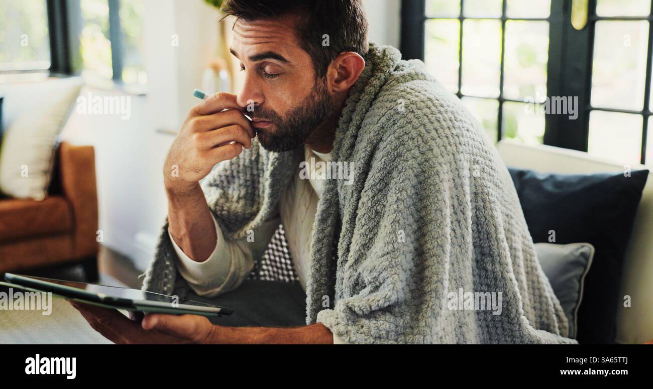 Tablet, man and sick with thermometer on sofa, check fever and ...