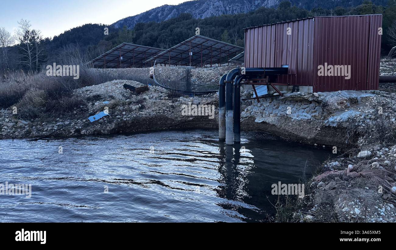 Water pump drawing water from a lake Stock Photo - Alamy