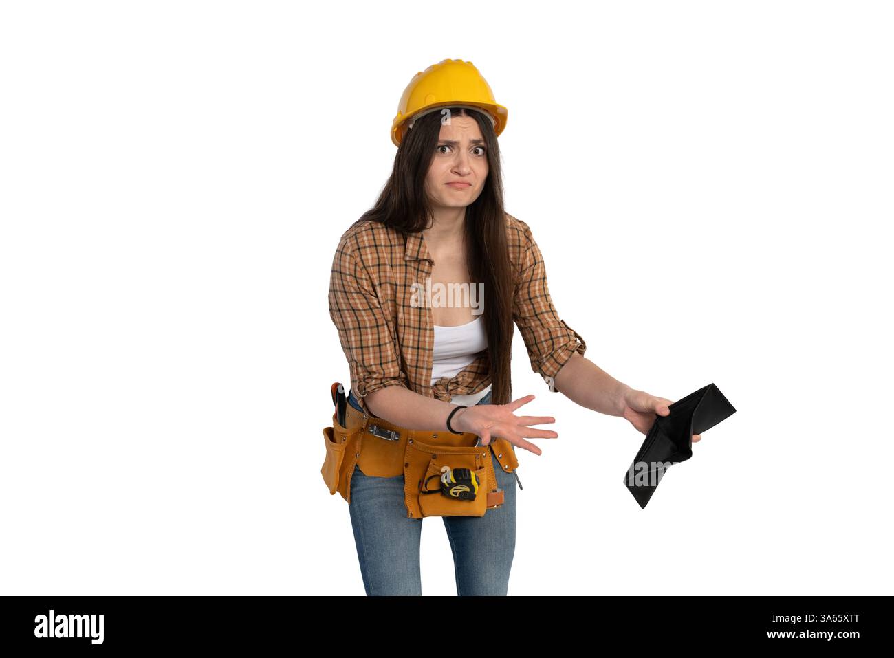 A concerned female construction worker in a tool belt and hard hat ...