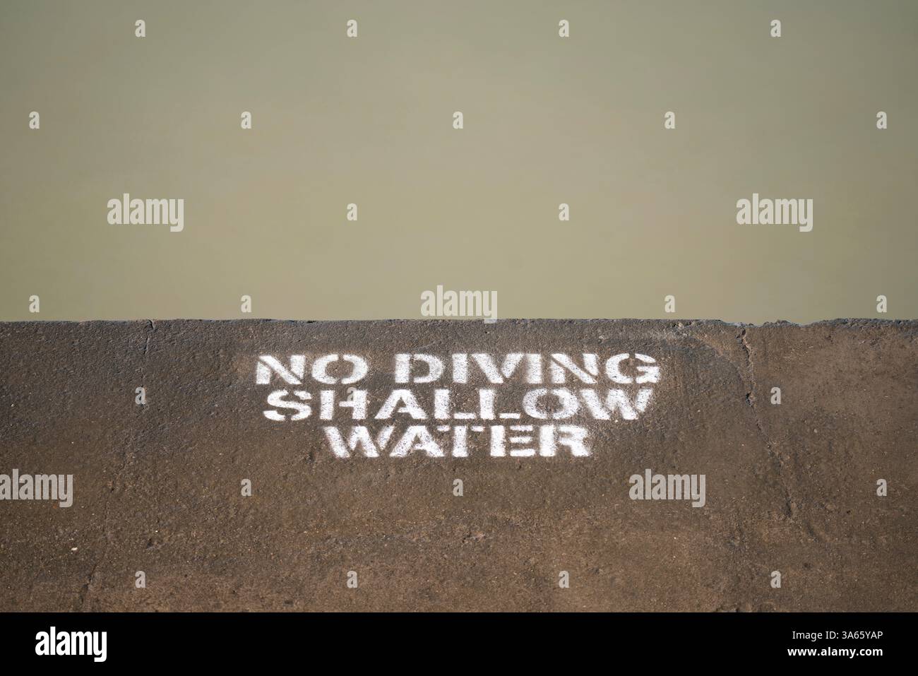 A NO DIVING SHALLOW WATER painted sign at the marine lake in Weston ...