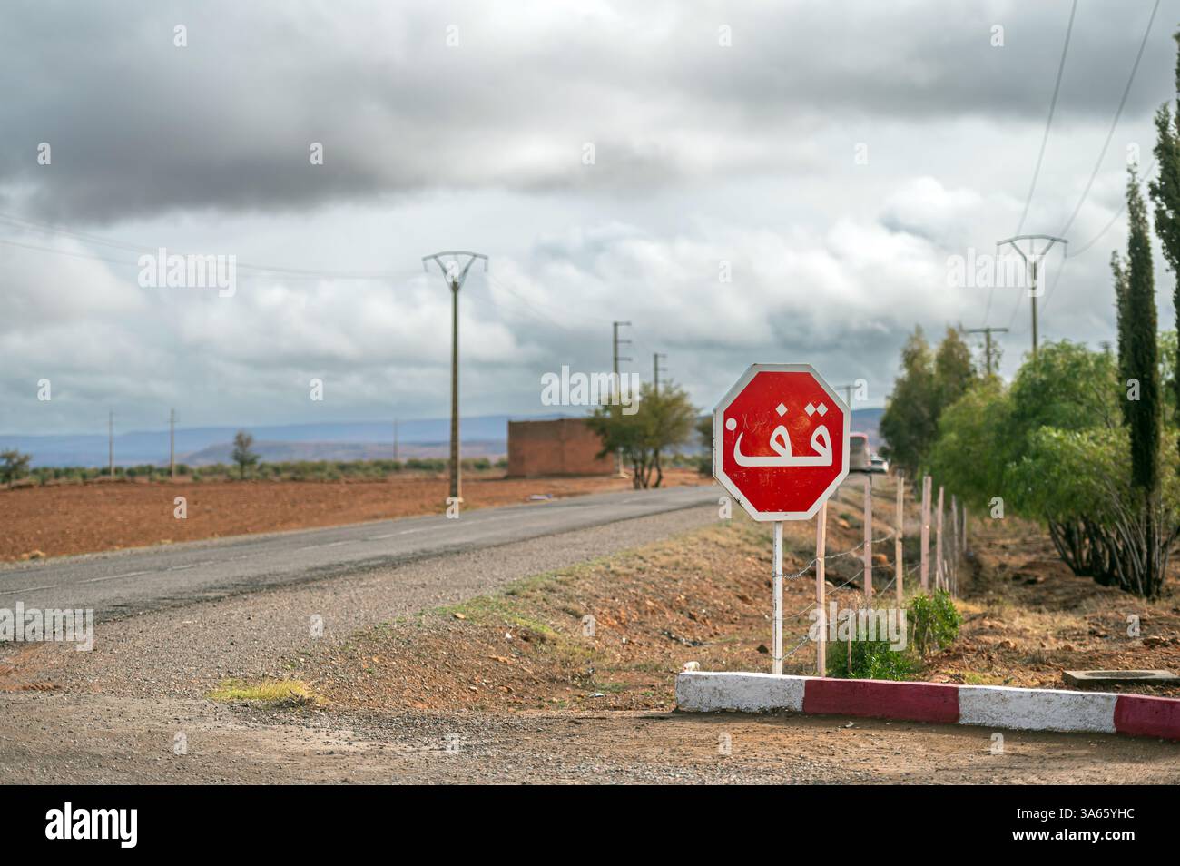 Traffic stop sign with Arabic script near rural road in Morocco Stock ...