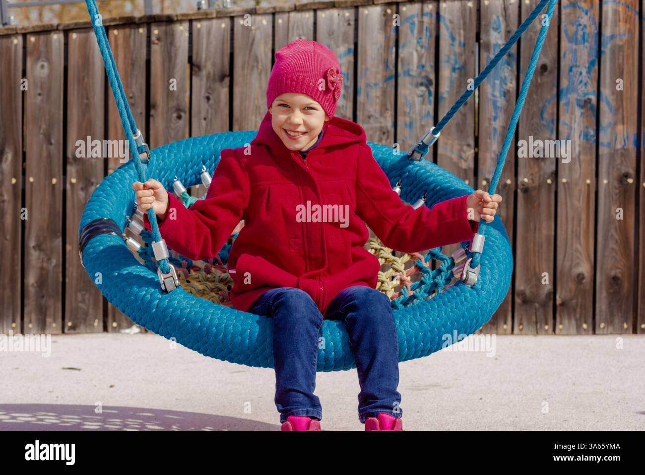Caucasian smiling child of 8 9 years swinging on round seesaw Stock ...