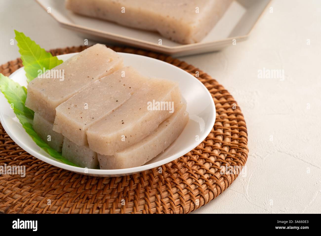 Raw konjac in square shape in a plate on white table background, also ...