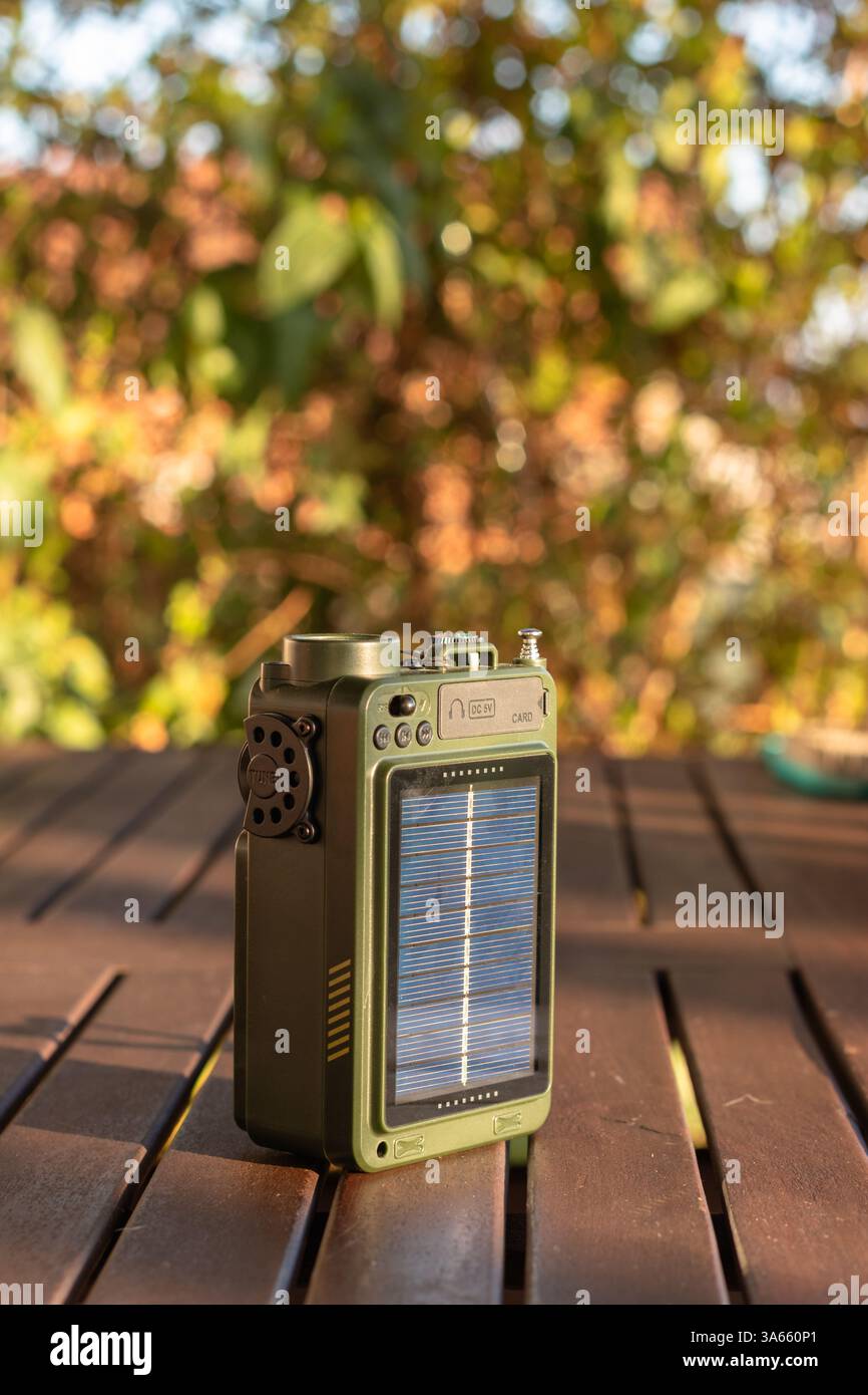 A compact electronic device with solar charging capability placed on a ...