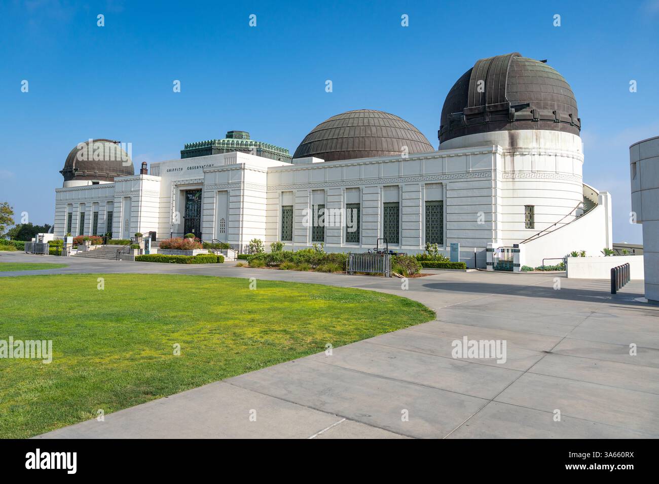A large white building featuring three distinctive dome shaped roofs ...