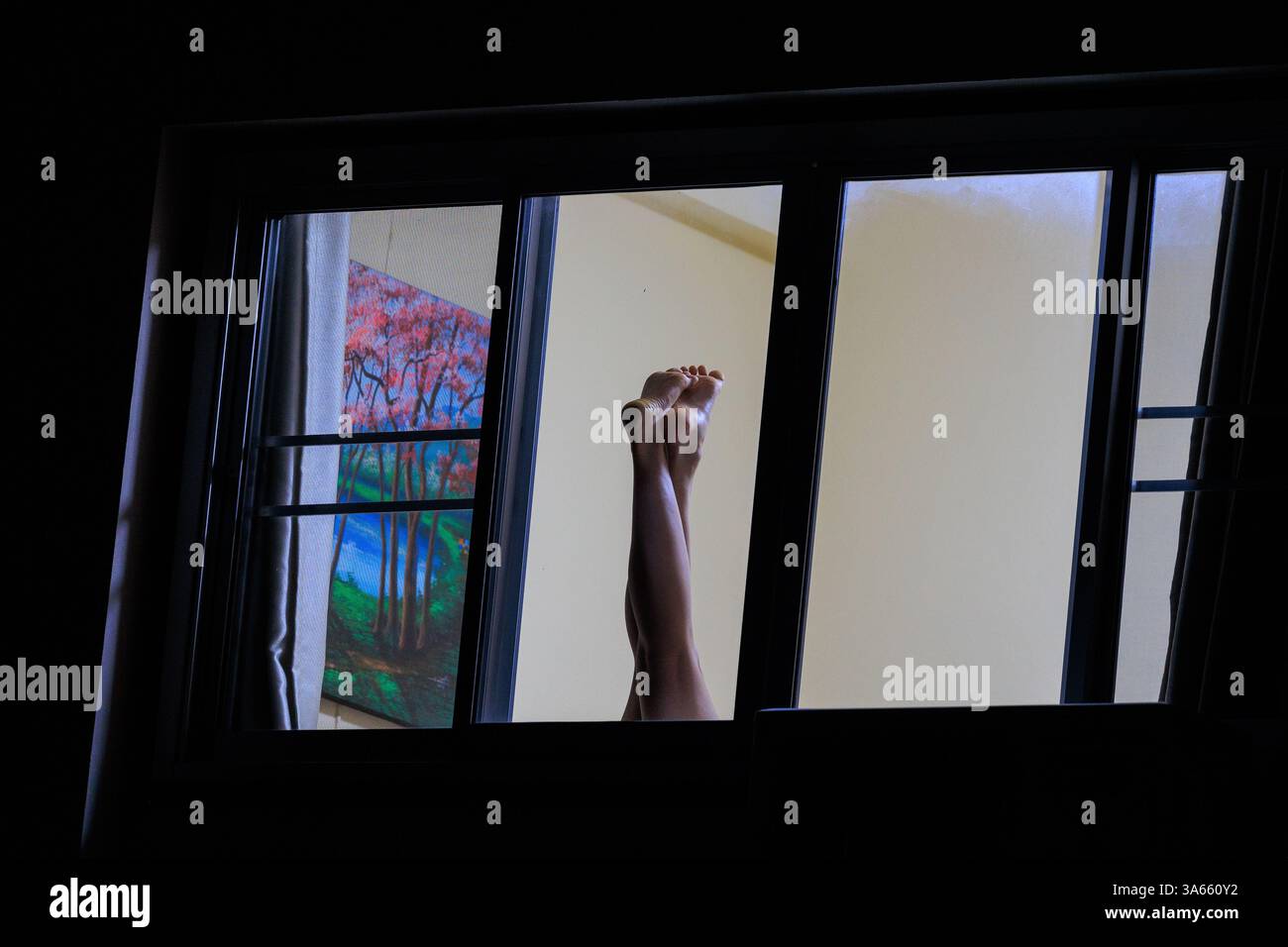 Chinese tourist woman relaxing in hotel room stretching her legs on the ...